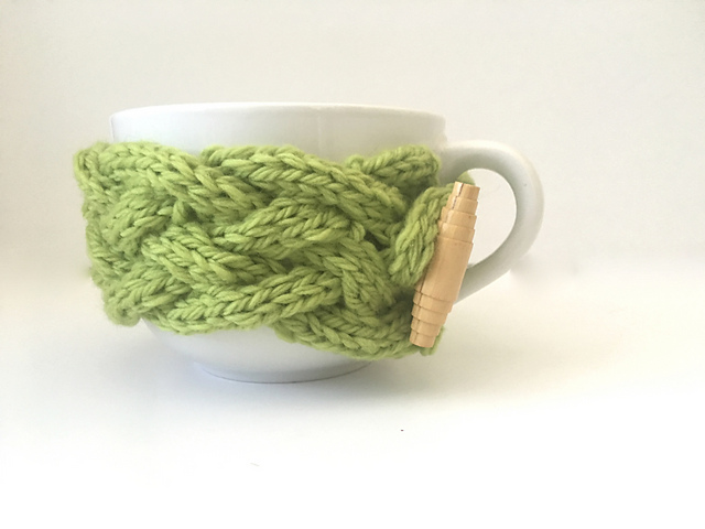 Ravelry: Triple Cable Coffee Cup Cozy pattern by Kristin Omdahl