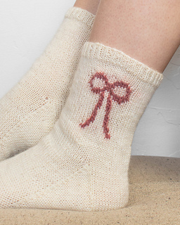 Ravelry: Adelia Bow Socks pattern by Emma Yochim